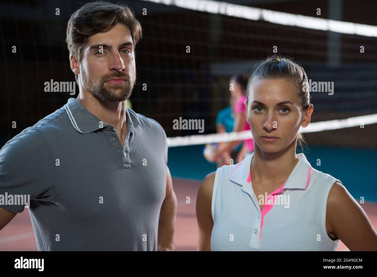 Portrait of confident volleyball players at court Stock Photo - Alamy