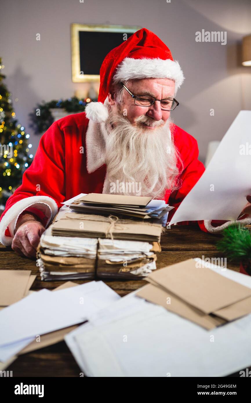 Santa Claus reading a letter Stock Photo - Alamy