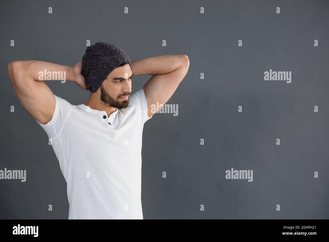 Handsome man standing with hands behind back Stock Photo - Alamy