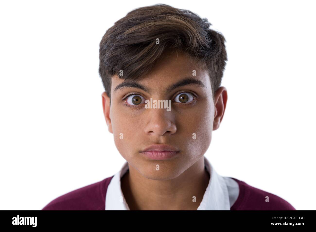 Shocked teenage boy standing against white background Stock Photo - Alamy
