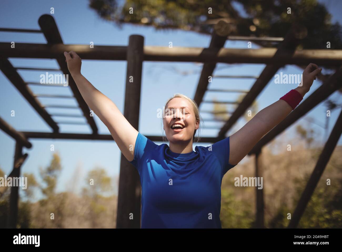 Happy woman exercising during obstacle course Stock Photo - Alamy