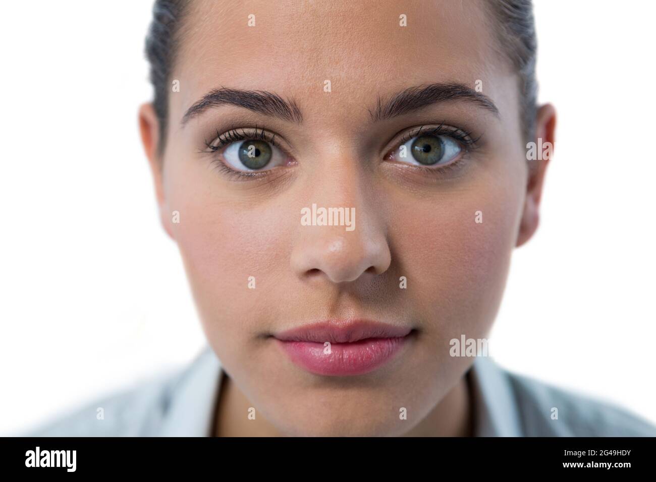 Surprised female executive standing against white background Stock ...