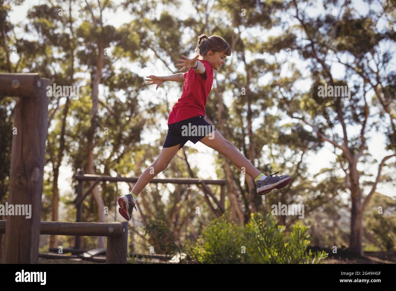Determined girl jumping over obstacle Stock Photo - Alamy