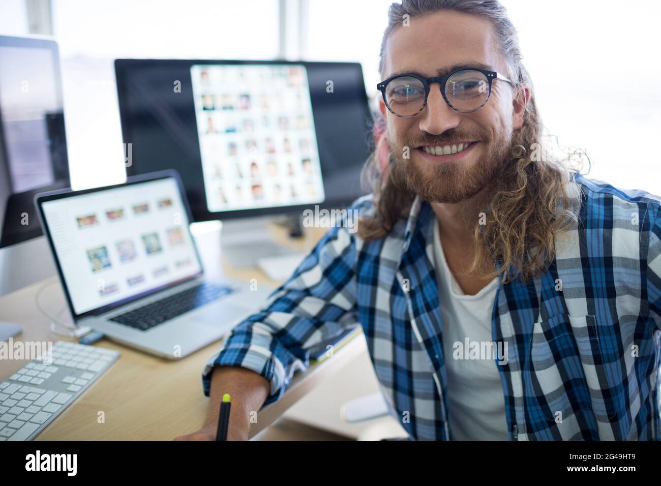Portrait of male executive sitting at his desk Stock Photo - Alamy