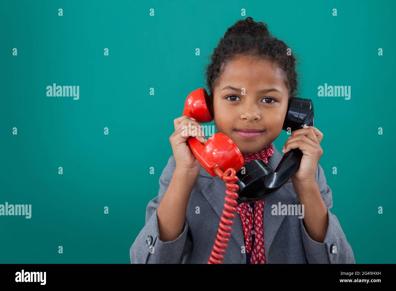 Portrait of businesswoman talking land line phones Stock Photo - Alamy