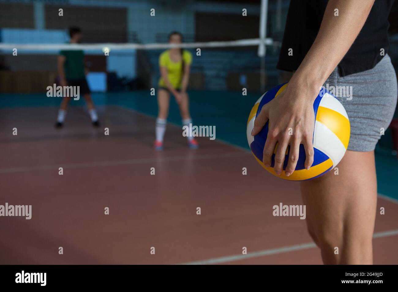 Mid section side view of player holding volleyball Stock Photo - Alamy