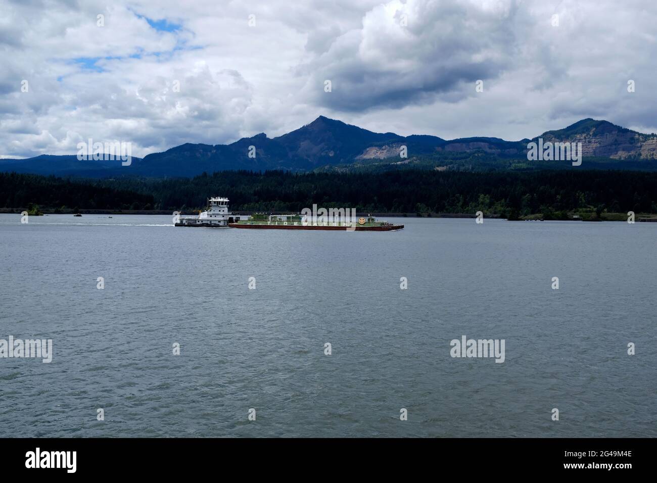 A barge pushing a tanker on the Columbia River near Cascade Locks ...