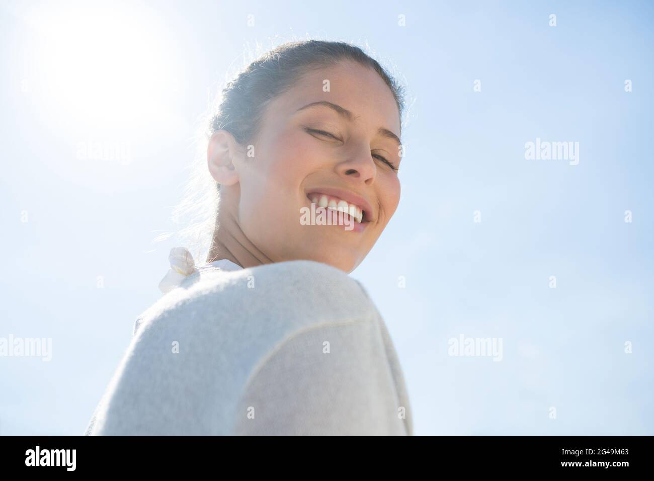 Low angle portrait of smiling woman Stock Photo - Alamy