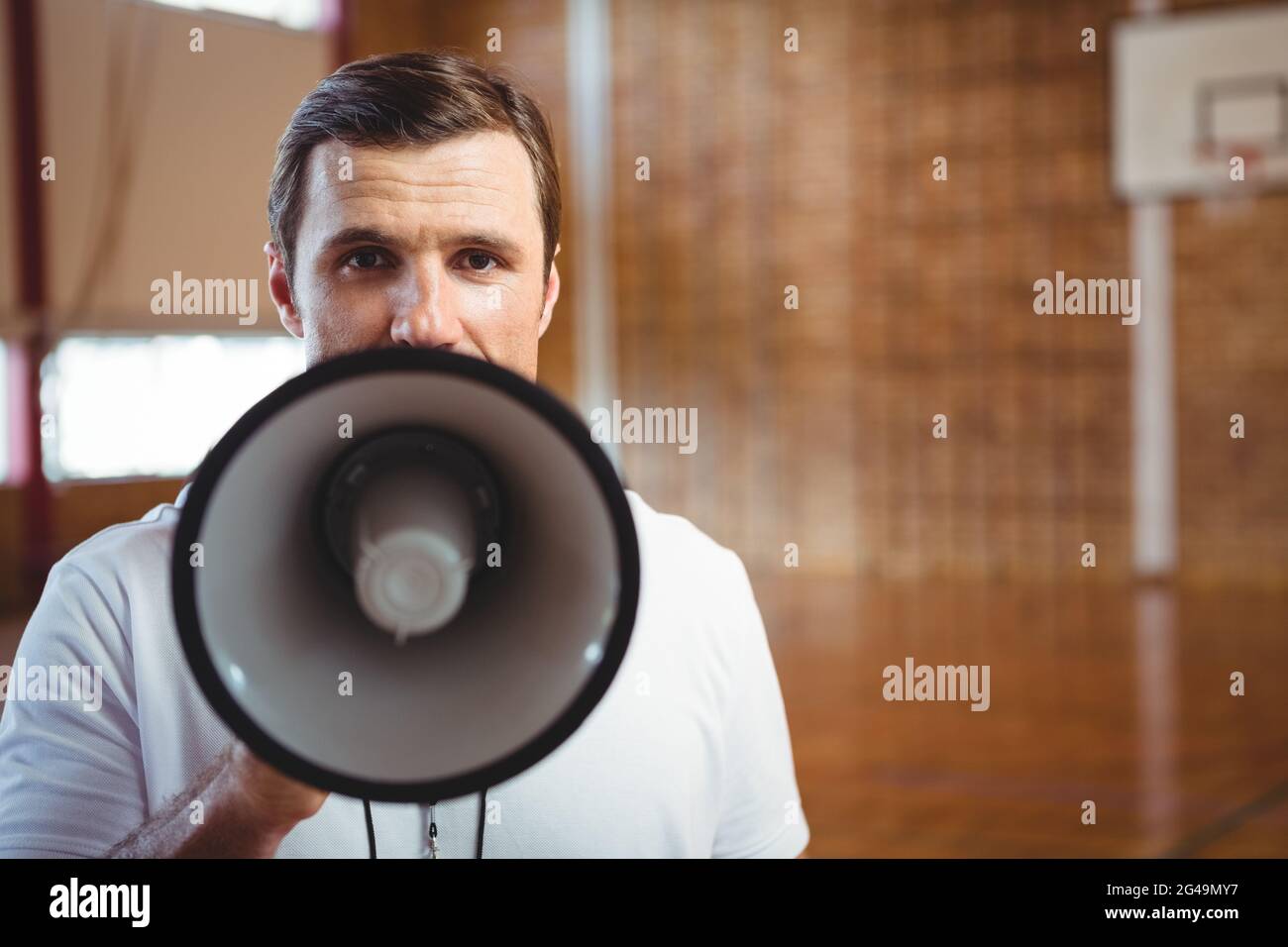 Portrait of male coach using megaphone Stock Photo - Alamy
