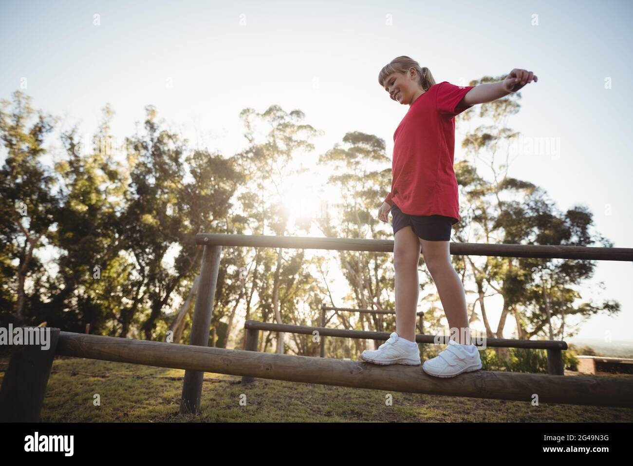 Girl walking on obstacle during obstacle course Stock Photo - Alamy