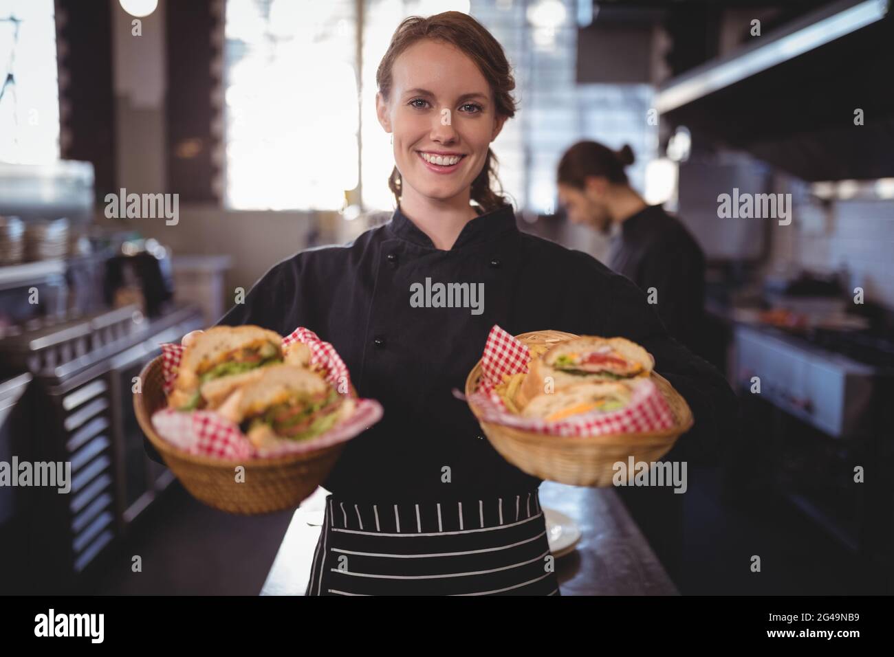 Smiling waitress serving meal hi-res stock photography and images - Alamy