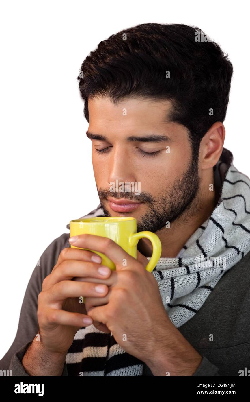 Man smelling a mug of coffee against white background Stock Photo - Alamy