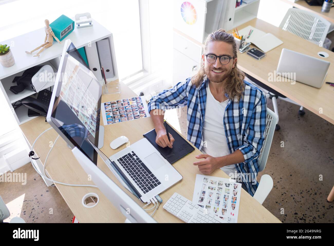 Portrait of male executive sitting at his desk Stock Photo - Alamy