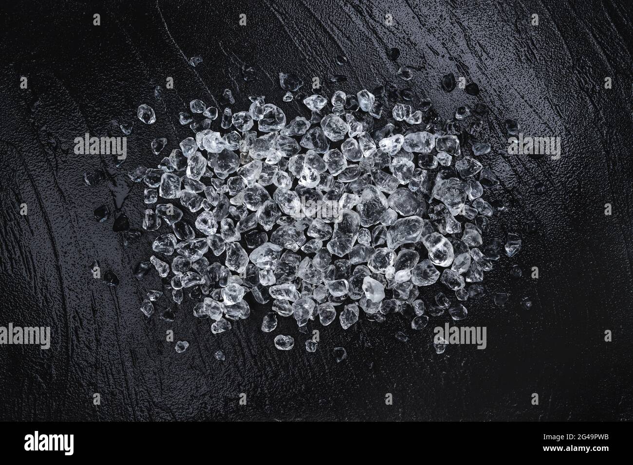 Pile of crushed ice on black stone background Stock Photo - Alamy