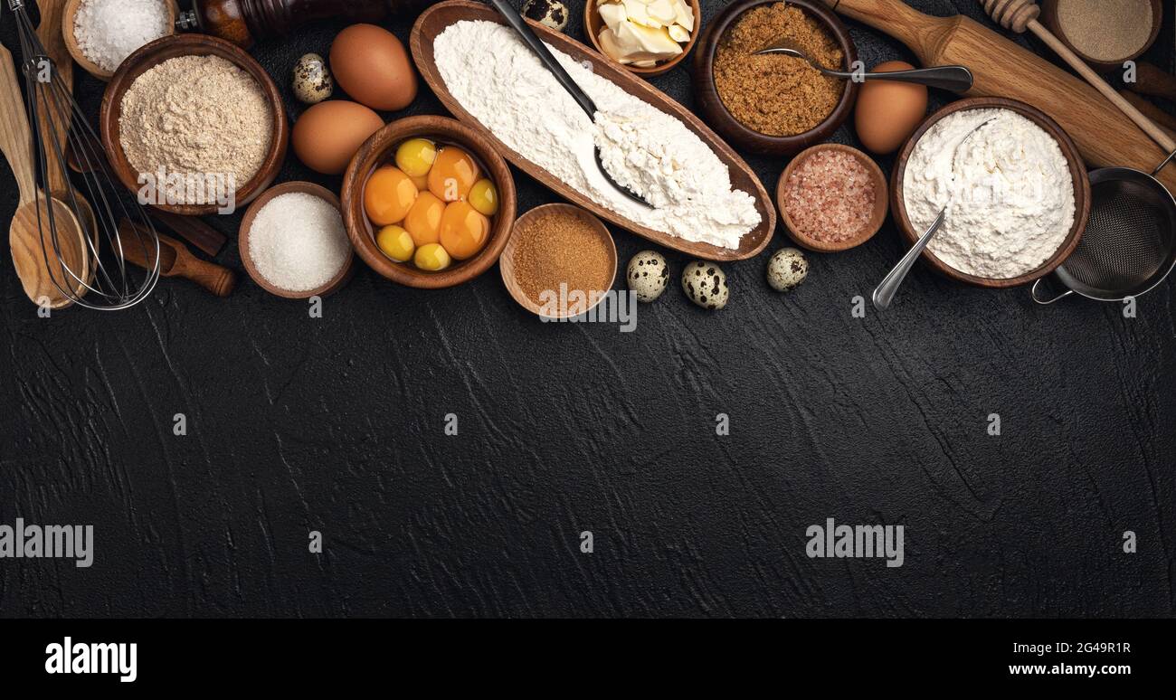 Baking ingredients on black background, top view Stock Photo - Alamy