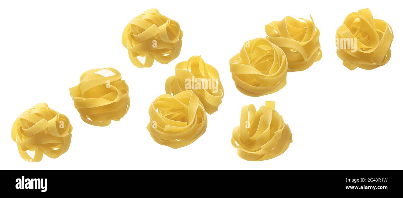 Falling raw tagliatelle pasta isolated on white background Stock Photo ...