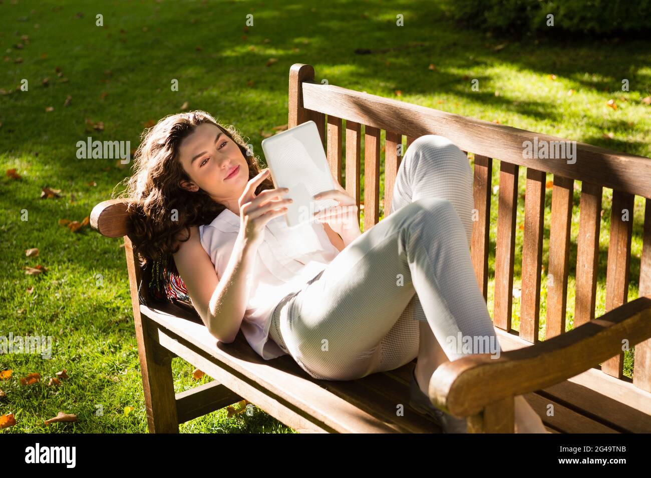 Woman lying on garden bench hi-res stock photography and images - Alamy