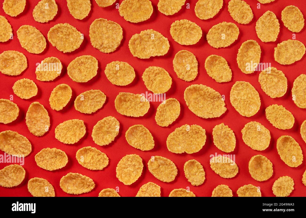 Pattern of corn flakes on red color background, top view Stock Photo ...