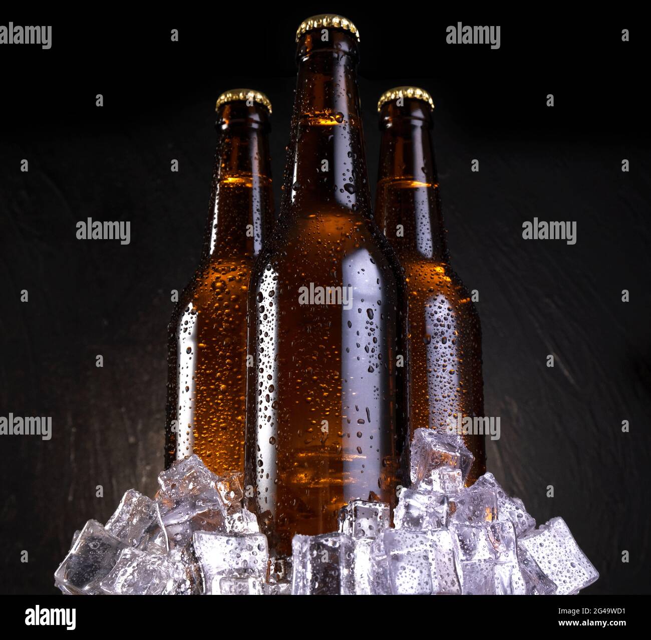 Cold beer with water drops, beer bottles with ice cubes Stock Photo - Alamy