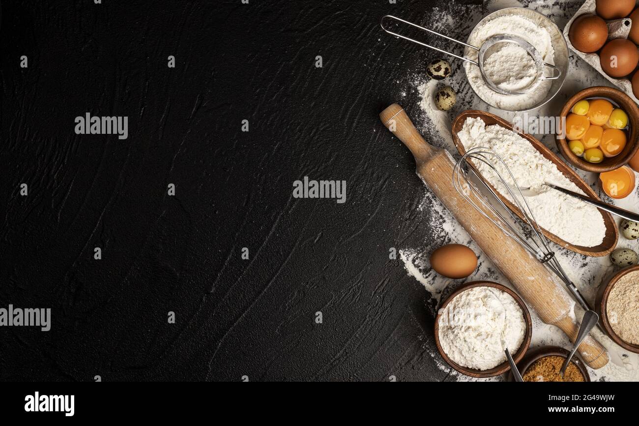 Baking ingredients on black background, top view Stock Photo - Alamy