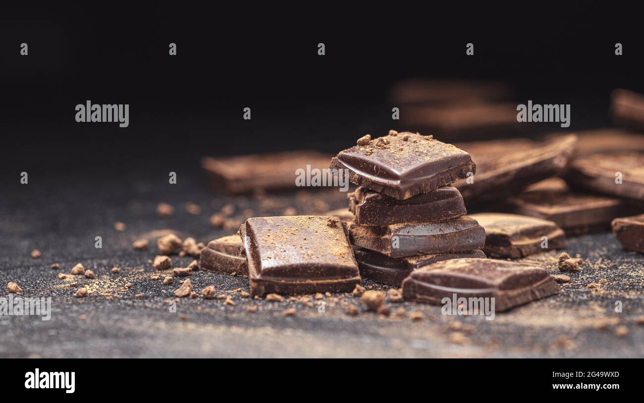 Chocolate bars on black slate background with cocoa powder Stock Photo ...