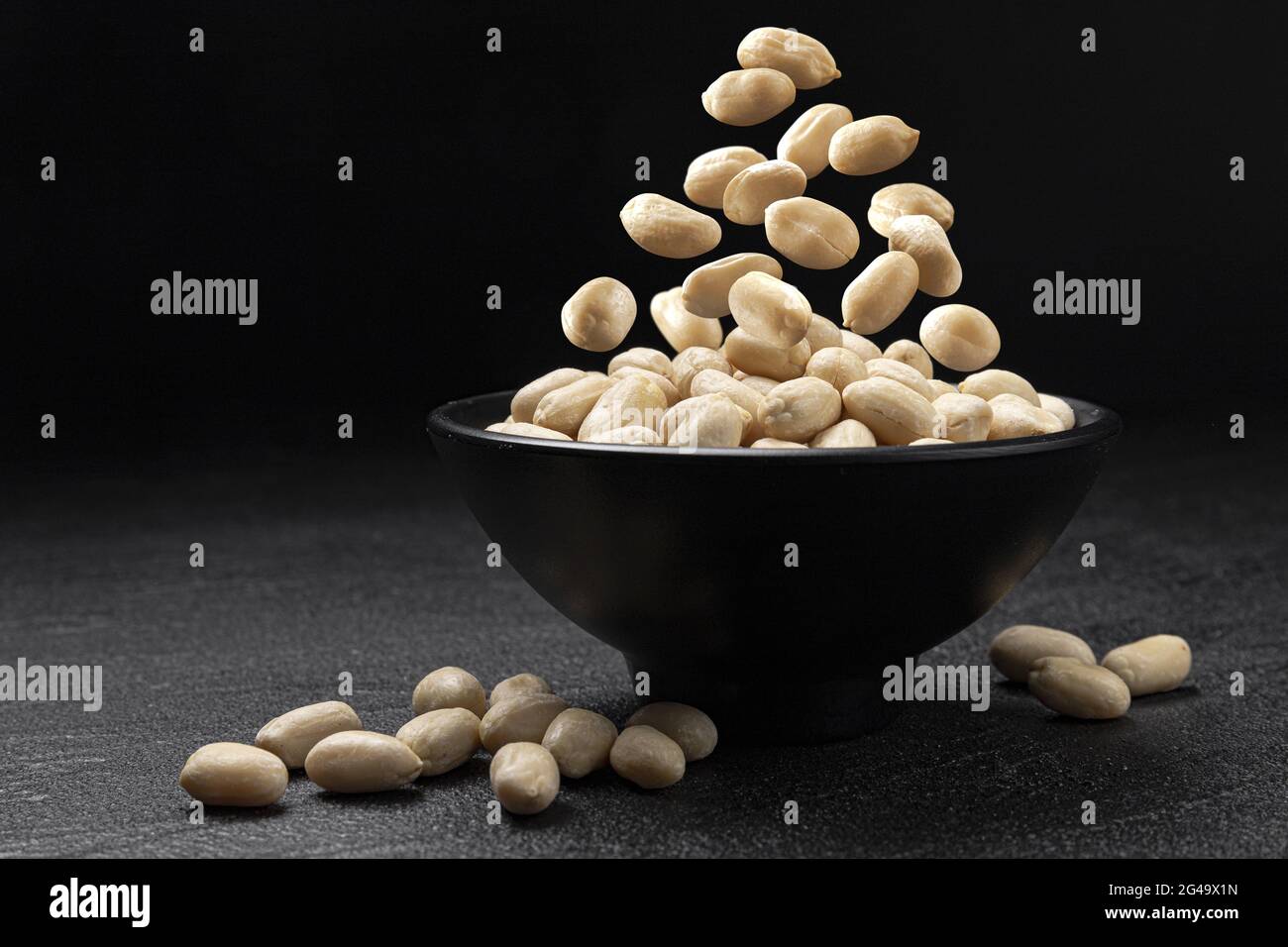 Falling peanut on black background with copy space Stock Photo - Alamy