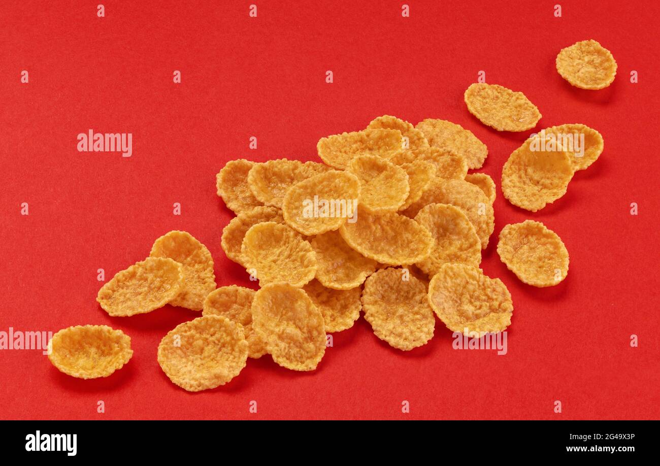 Corn flakes isolated on red color background, full depth of field Stock ...