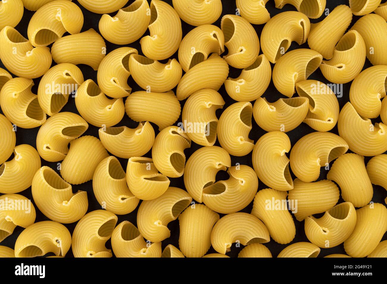 Pipe rigate pasta pattern on black background, top view, flat lay ...