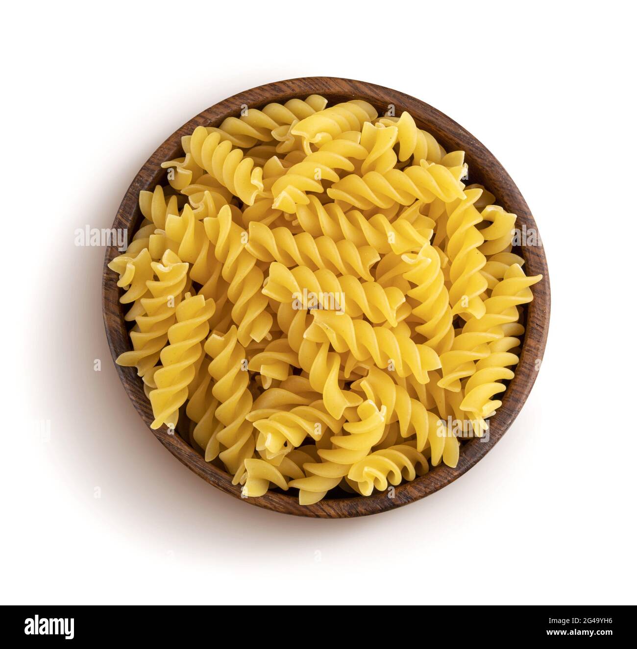 Fusilli pasta in wooden bowl isolated on white background, top view ...