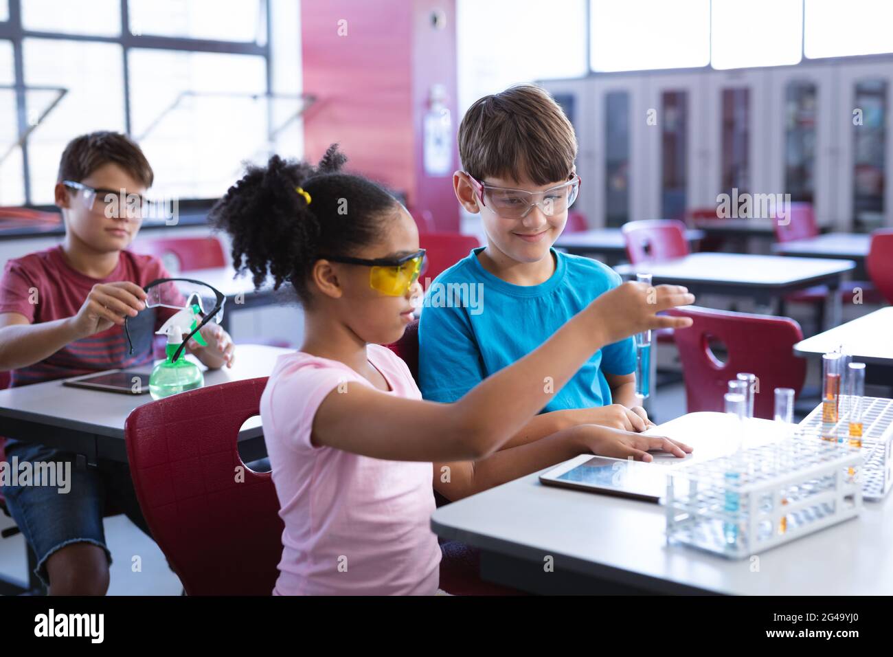 African american girl and caucasian boy holding test tube in science ...