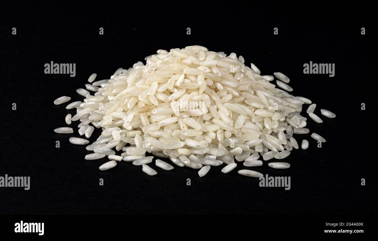 Heap of rice isolated on black background Stock Photo - Alamy