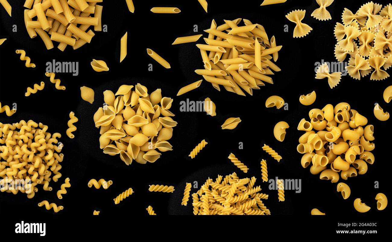 Different pasta types on black background, italian food texture, top ...