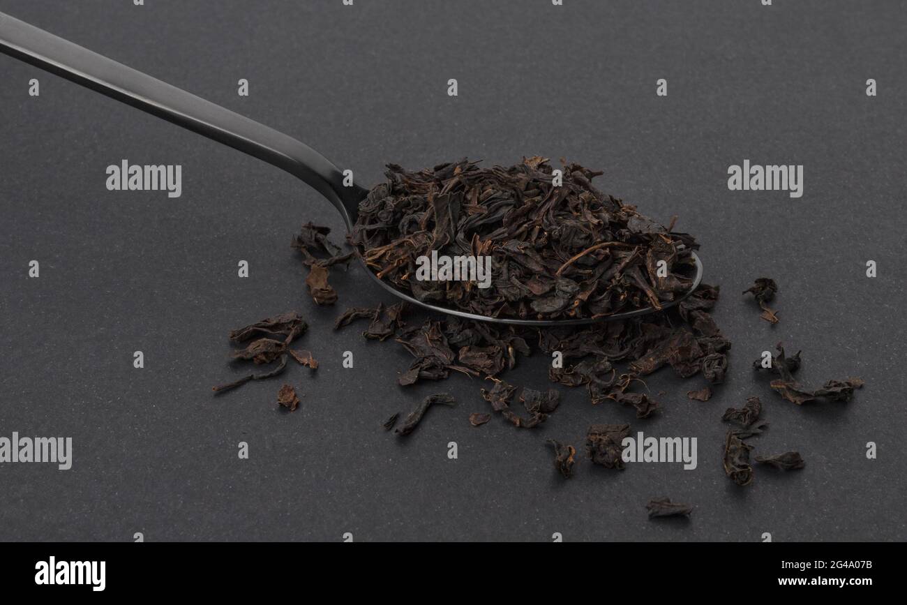 Dry black tea leaves isolated on white background Stock Photo - Alamy