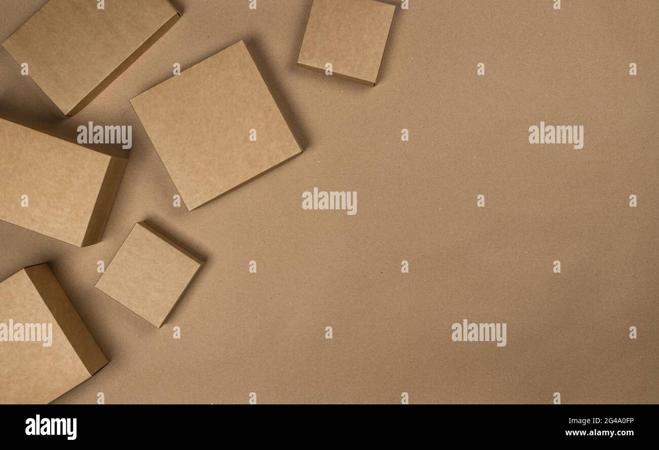 Brown cardboard boxes on craft paper background, top view Stock Photo ...