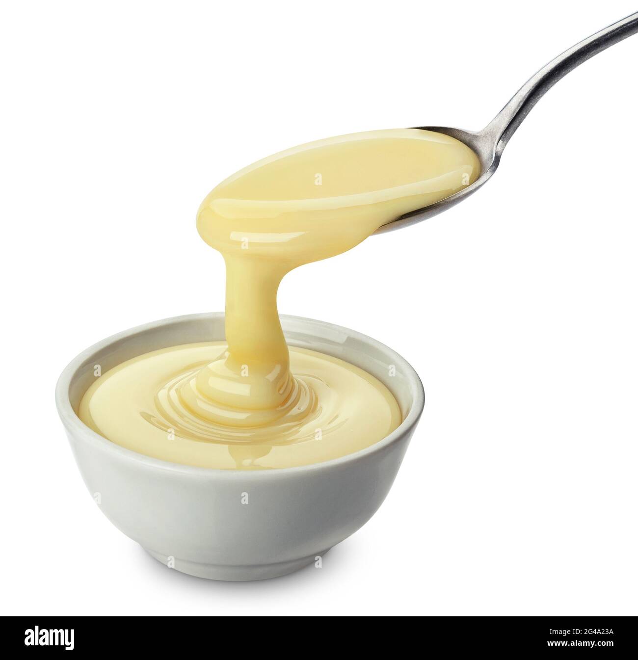 Pouring condensed milk isolated on white background Stock Photo - Alamy