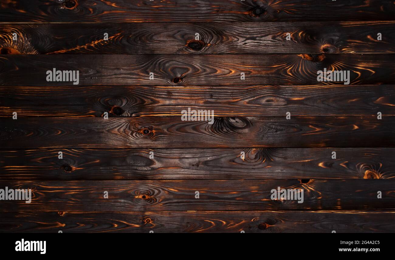Burnt wooden board, black charcoal wood texture, burned barbecue ...