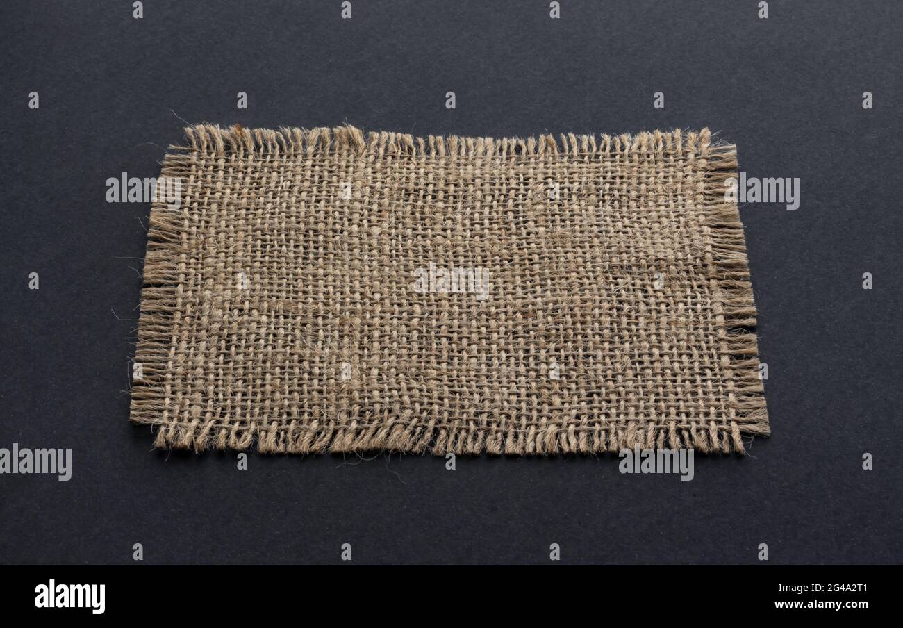 Old burlap fabric napkin on black background Stock Photo - Alamy