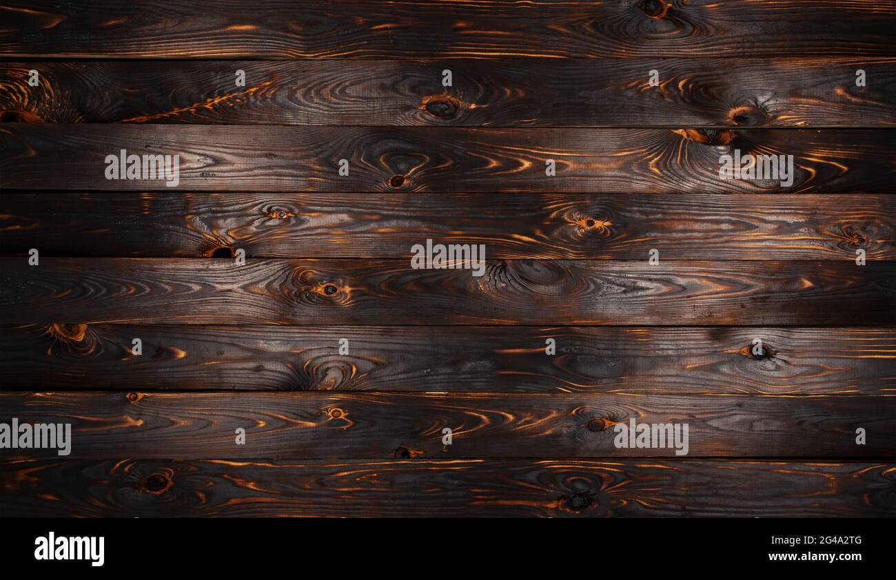 Burnt wooden board, black charcoal wood texture, burned barbecue ...