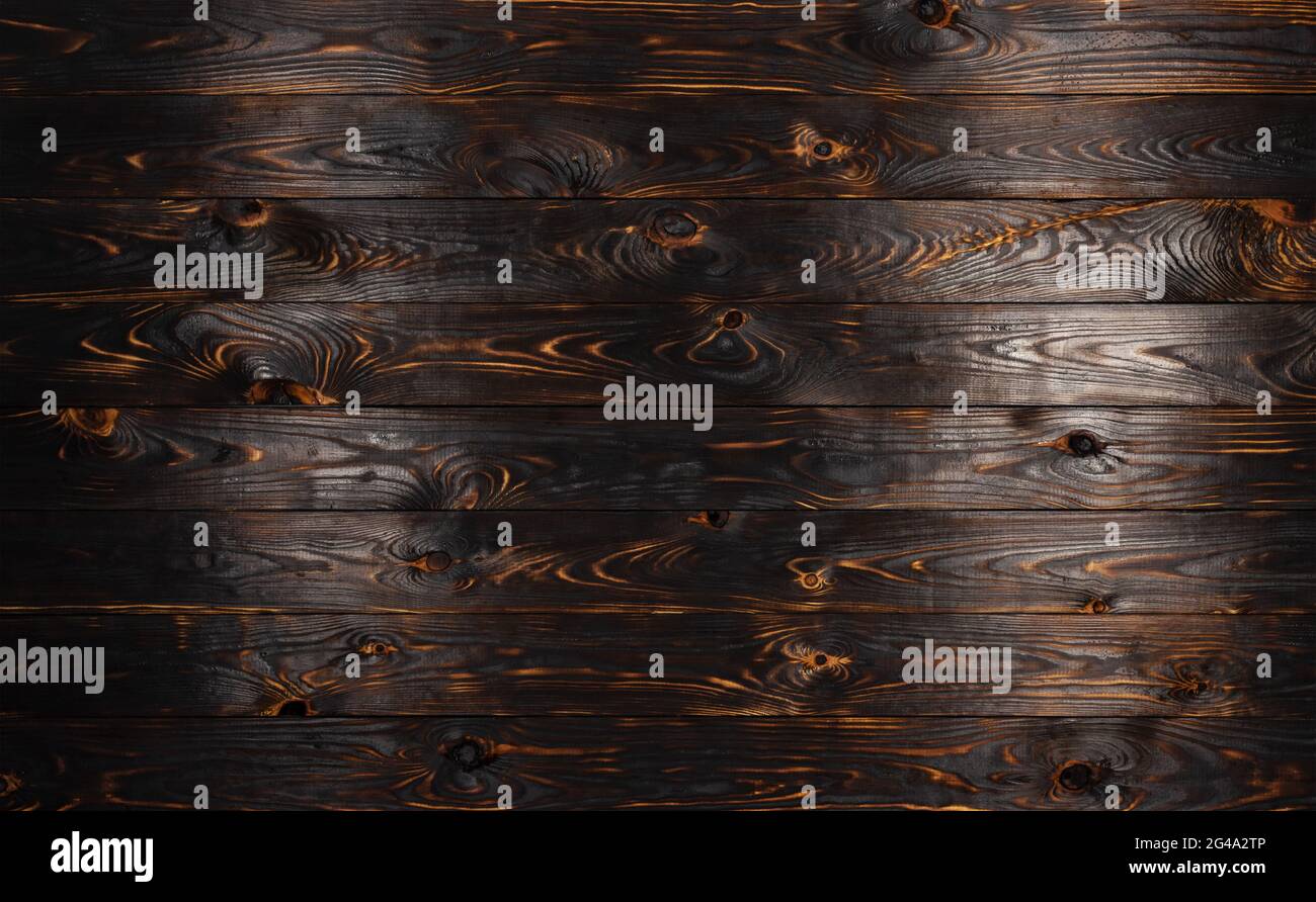 Burnt wooden board, black charcoal wood texture, burned barbecue ...
