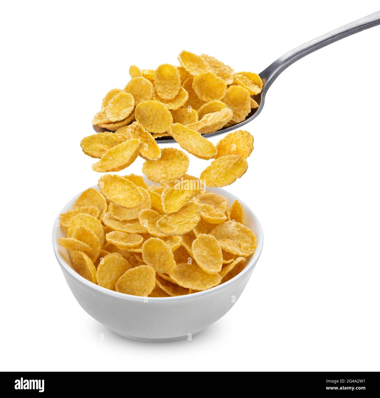 Corn flakes falling from spoon into bowl isolated on white background ...