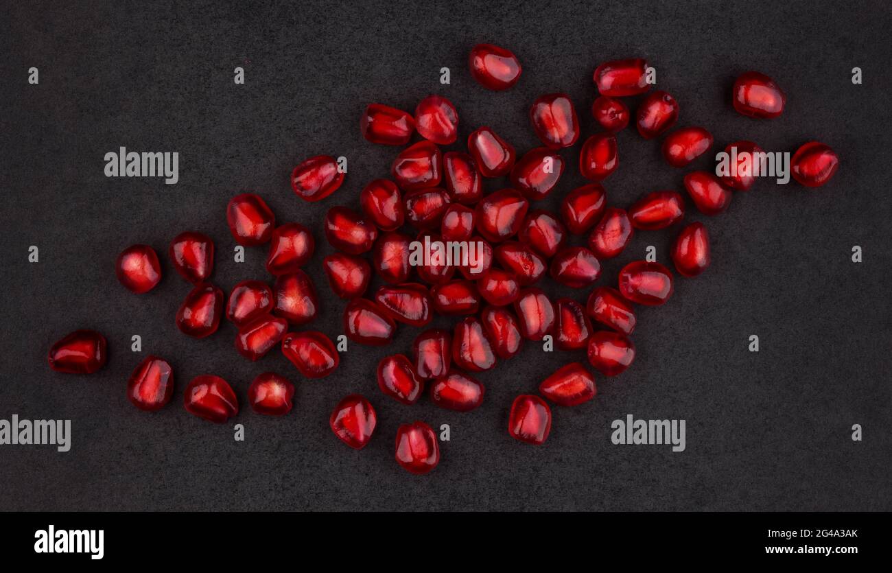Pomegranate seeds on black background, with empty space for text Stock ...