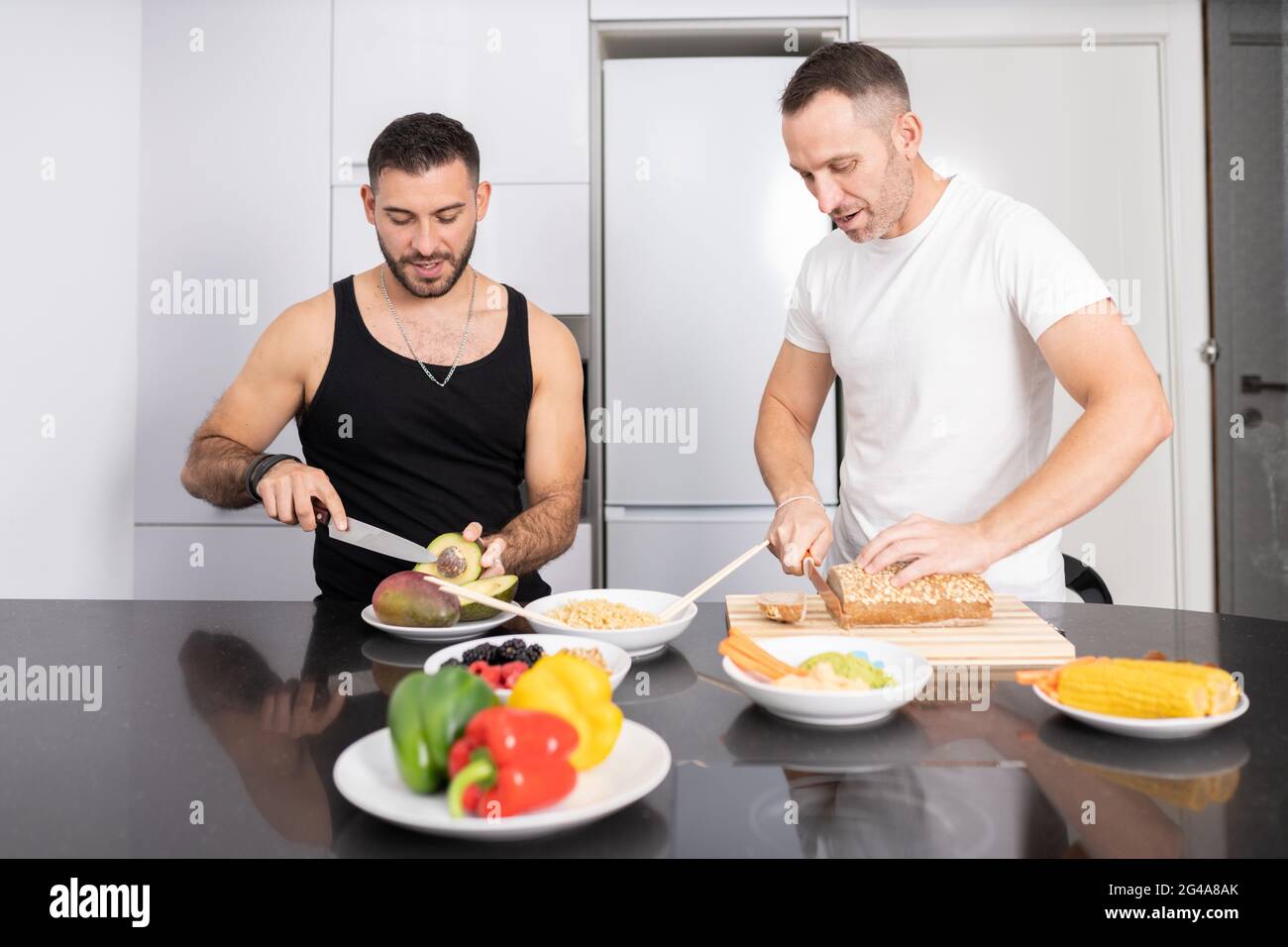 Gay couple cooking together hi-res stock photography and images - Alamy
