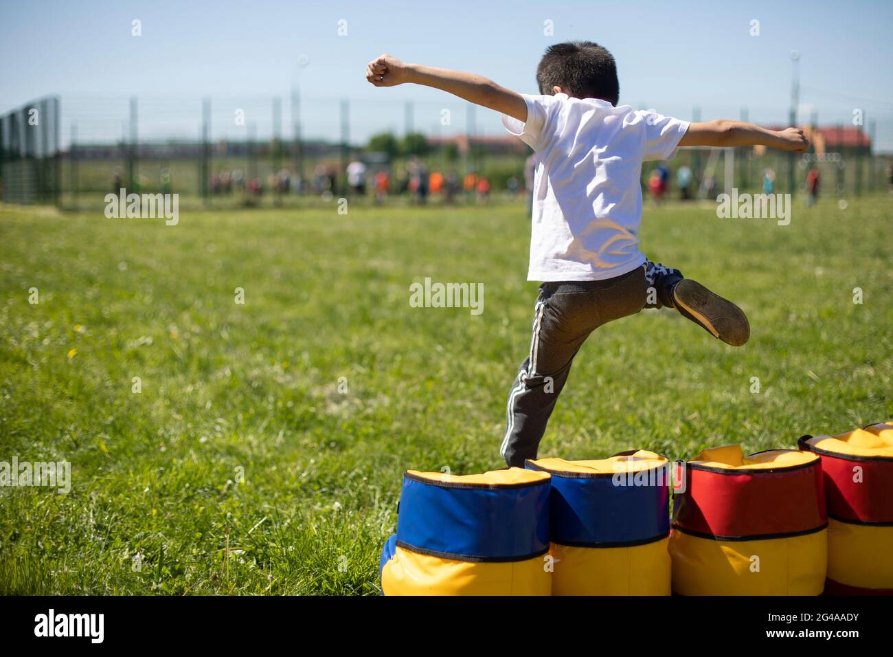 A child jumps over an inflatable obstacle. Obstacle course for children ...