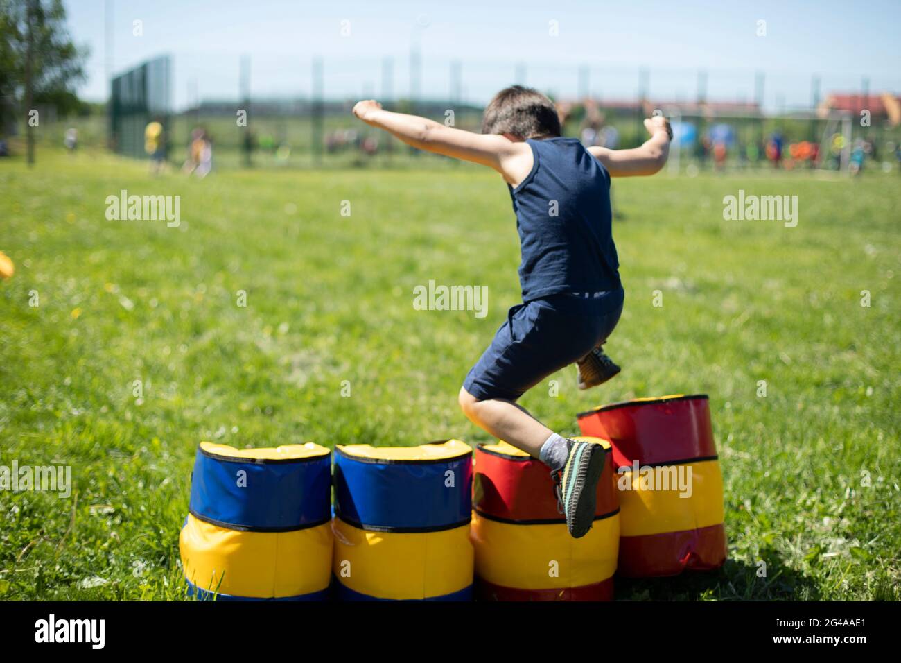 A child jumps over an inflatable obstacle. Obstacle course for children ...