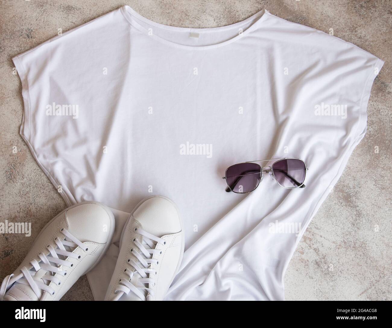 Stylish female clothes set. Woman outfit on concrete background. White ...