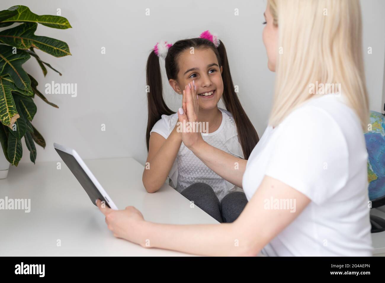 Online education of children. Mother and daughter of preschool watching ...