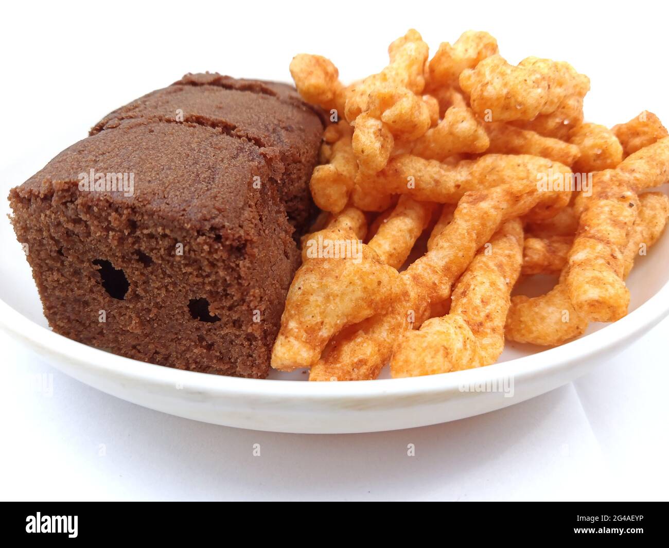 A closeup shot of chocolate cake and chips on a white plate Stock Photo ...