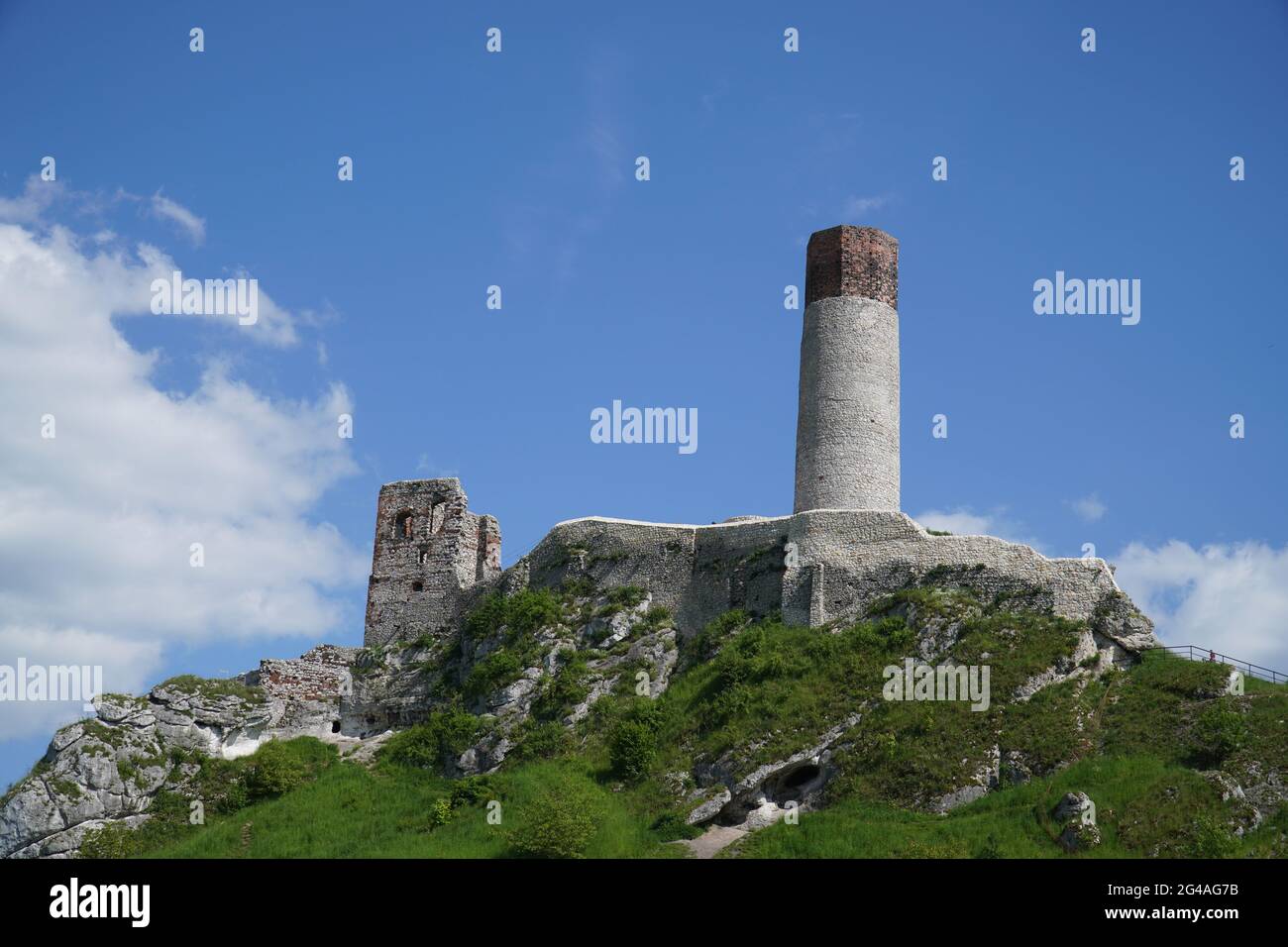A scenic view of the famous Olsztyn Castle in Poland under a blue sky ...