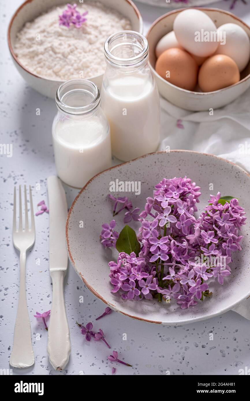 Sweet fried lilac flower with powdered sugar. Summer dessert. Lilac ...