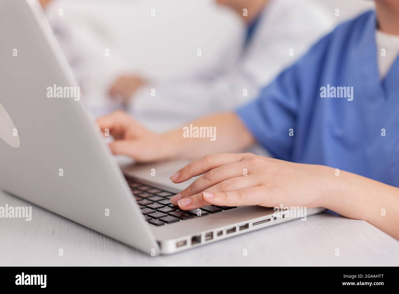 Close-up of practitioner nurse hands on keyboard typing medical disease ...